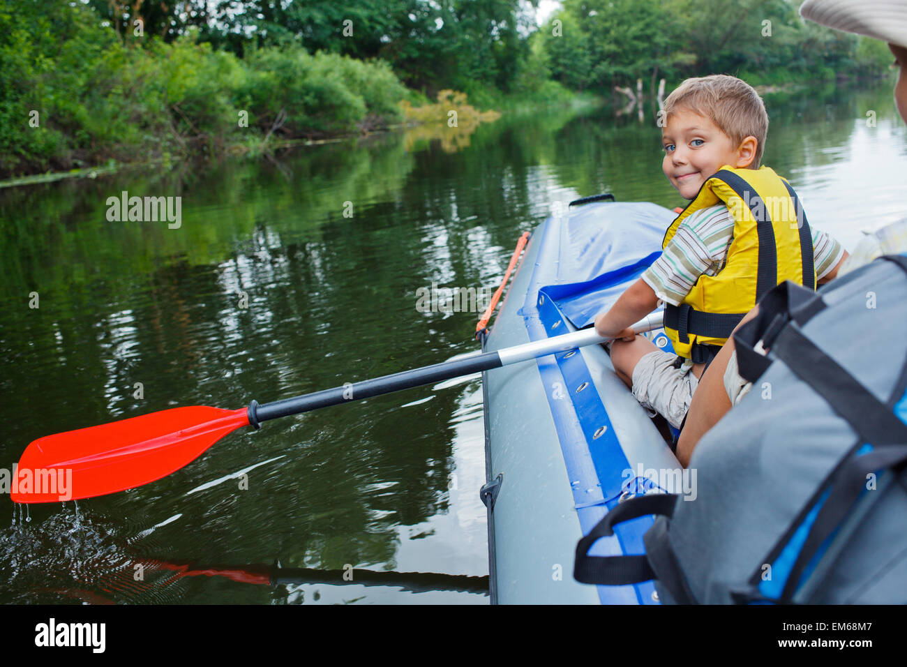 Young boy paddling kayak hi-res stock photography and images - Alamy