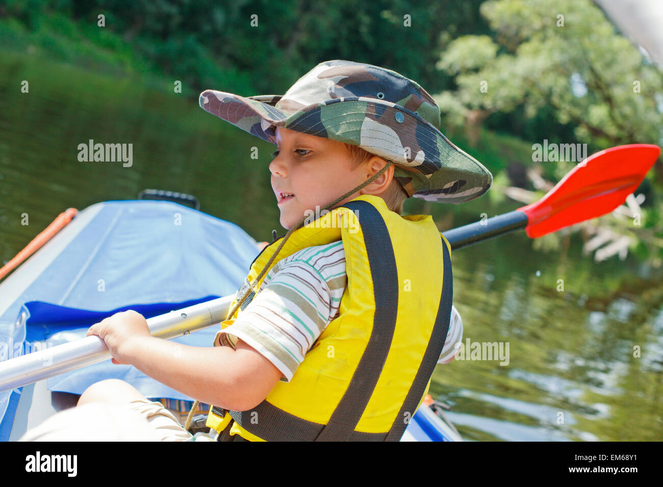 Young boy paddling kayak hi-res stock photography and images - Alamy