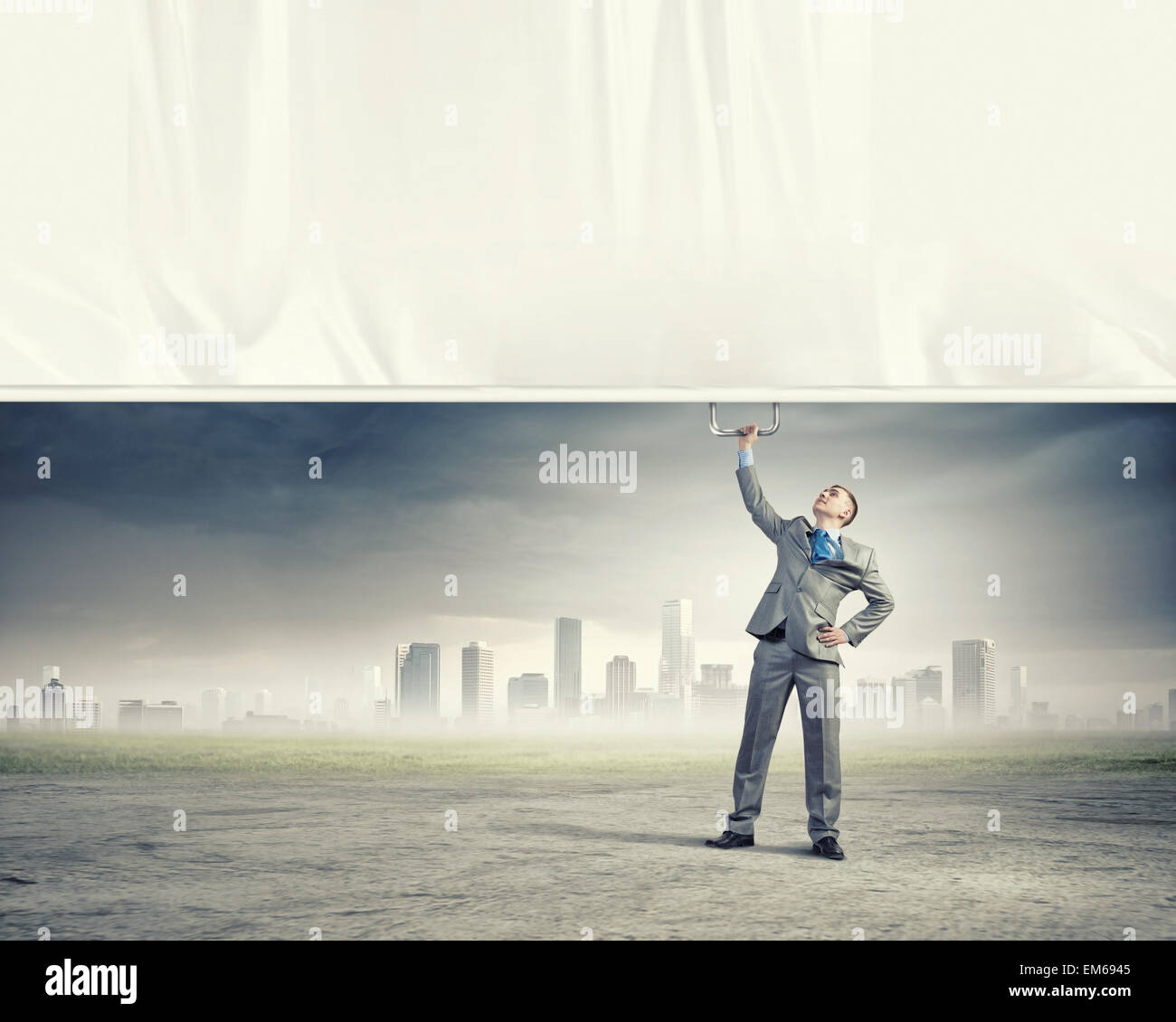 Young man pulling banner Stock Photo - Alamy