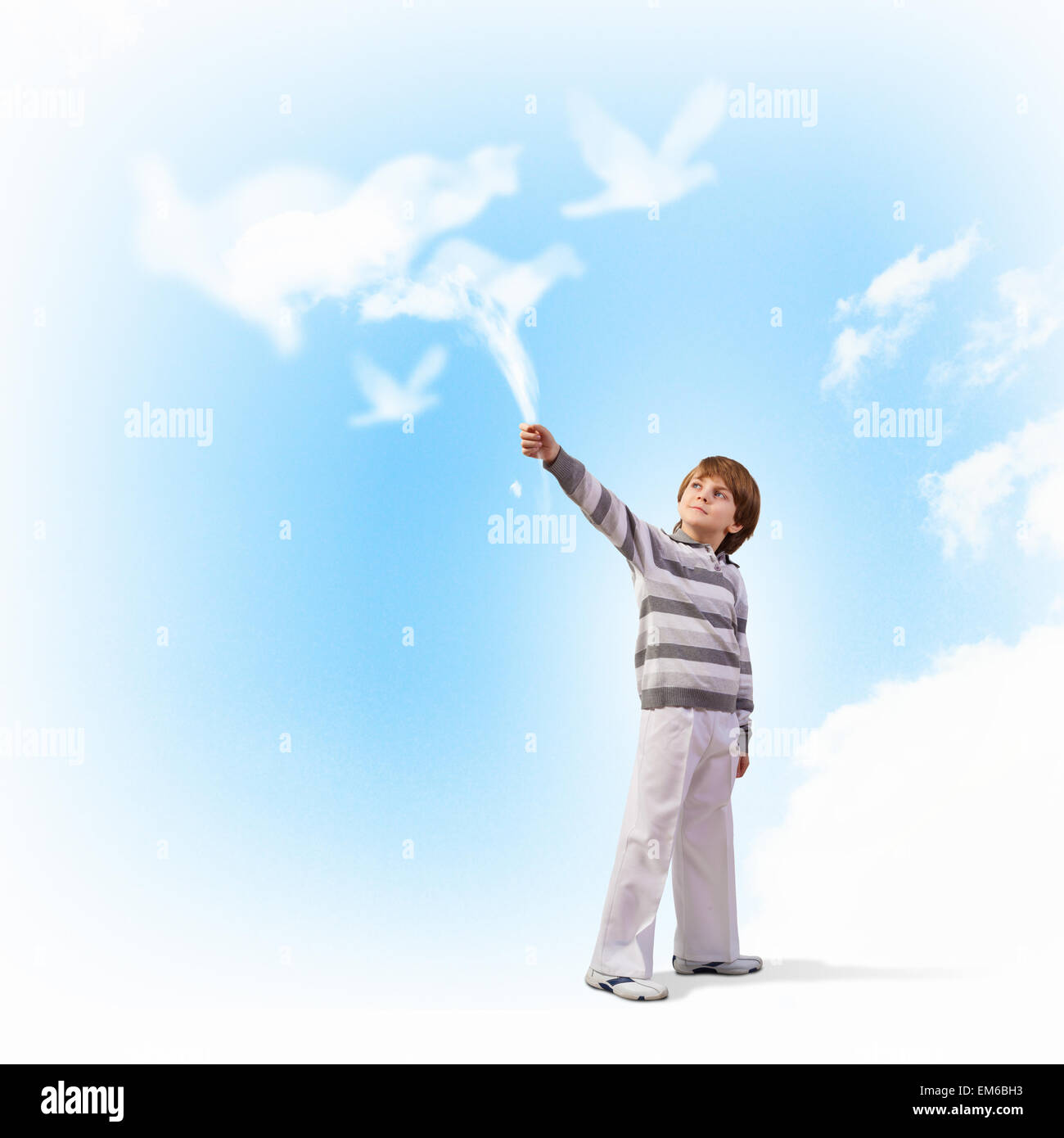 Cute boy catching clouds Stock Photo - Alamy