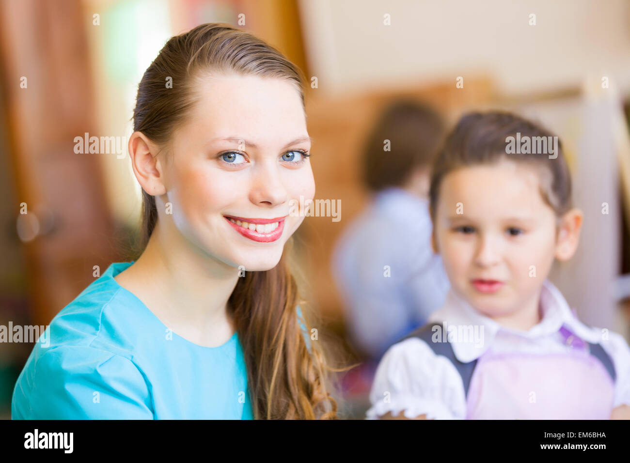 Cute girl and teacher Stock Photo - Alamy