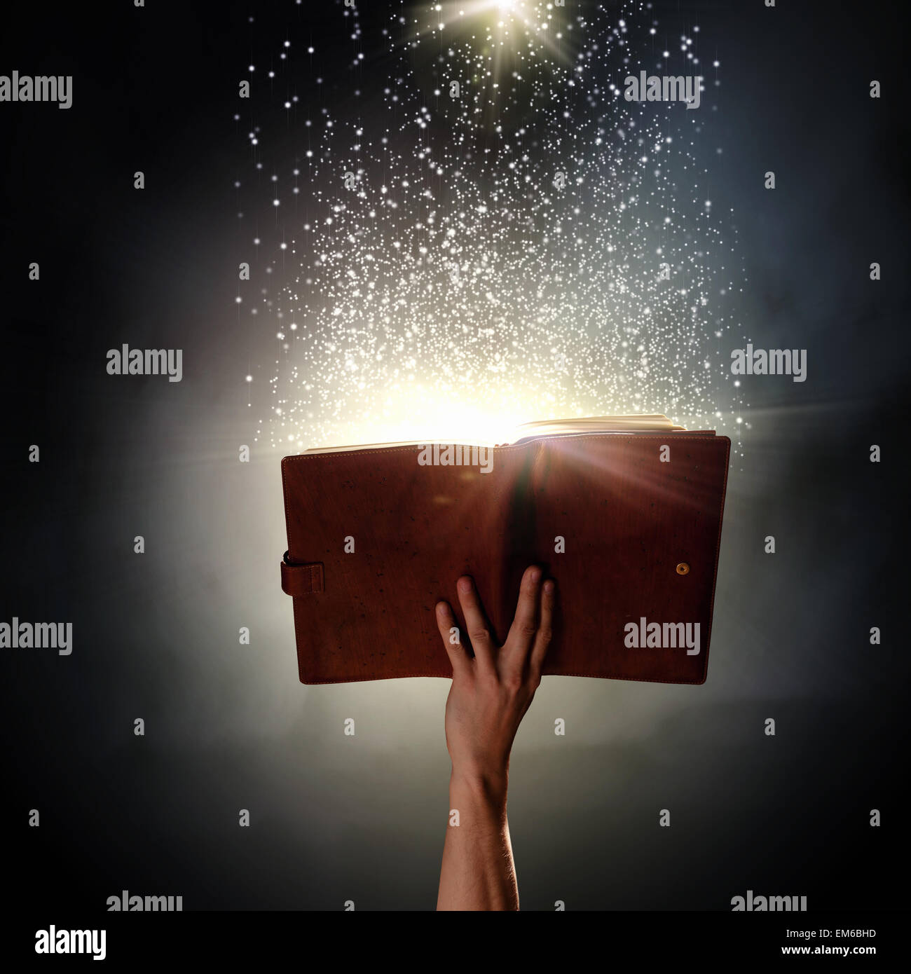 Hand with book Stock Photo - Alamy