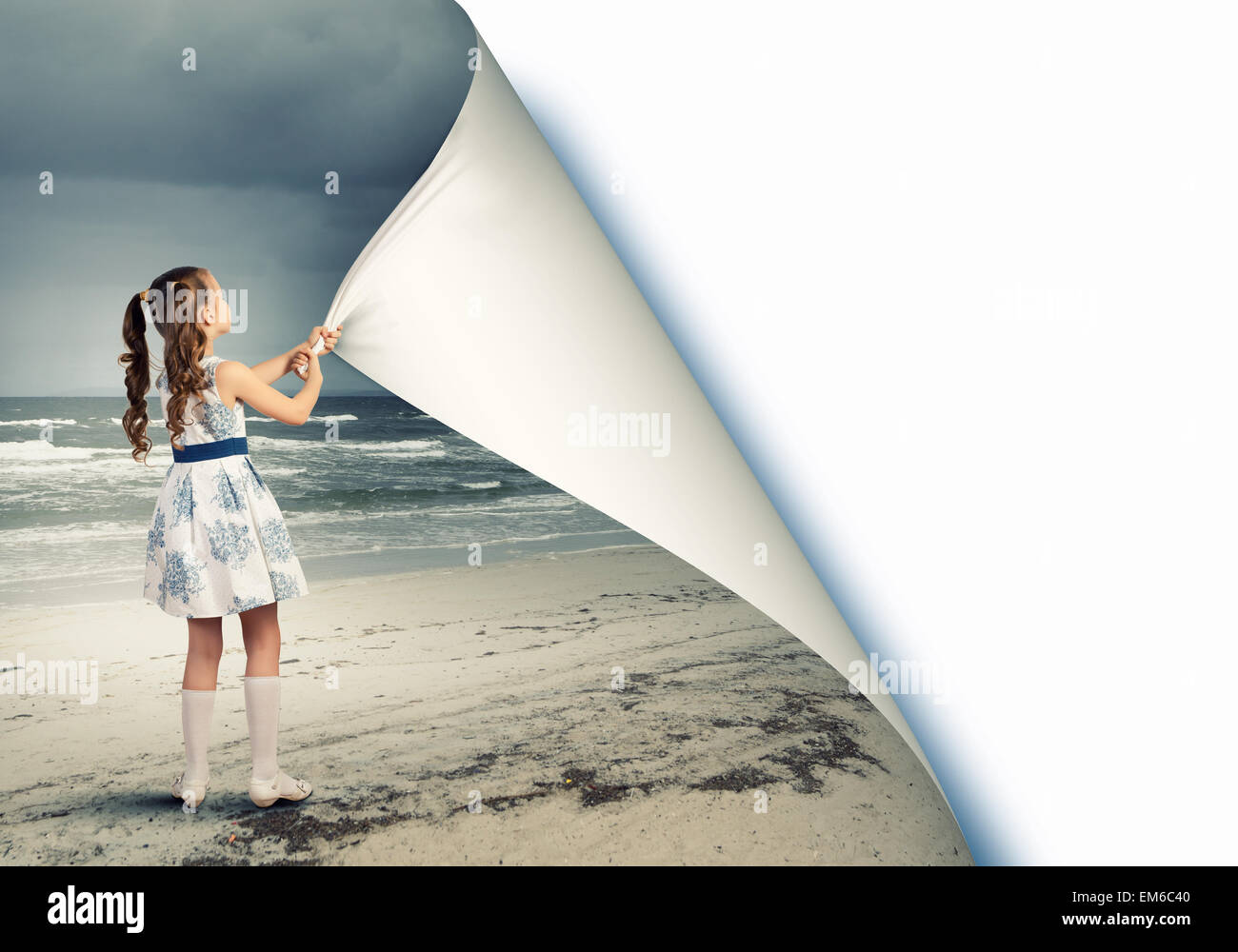 Little girl turning page Stock Photo - Alamy