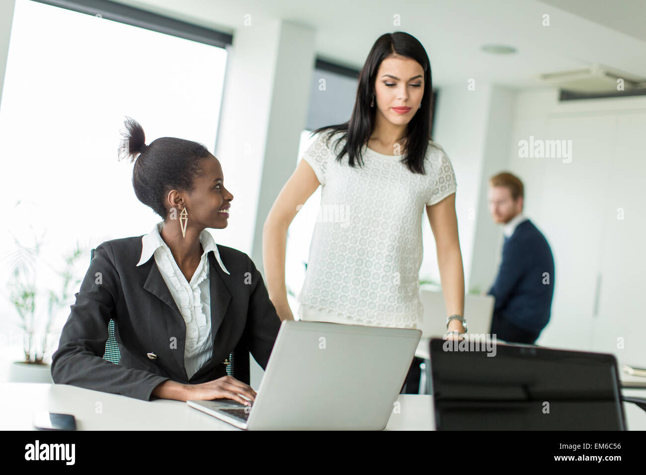 Young women working in the office Stock Photo - Alamy
