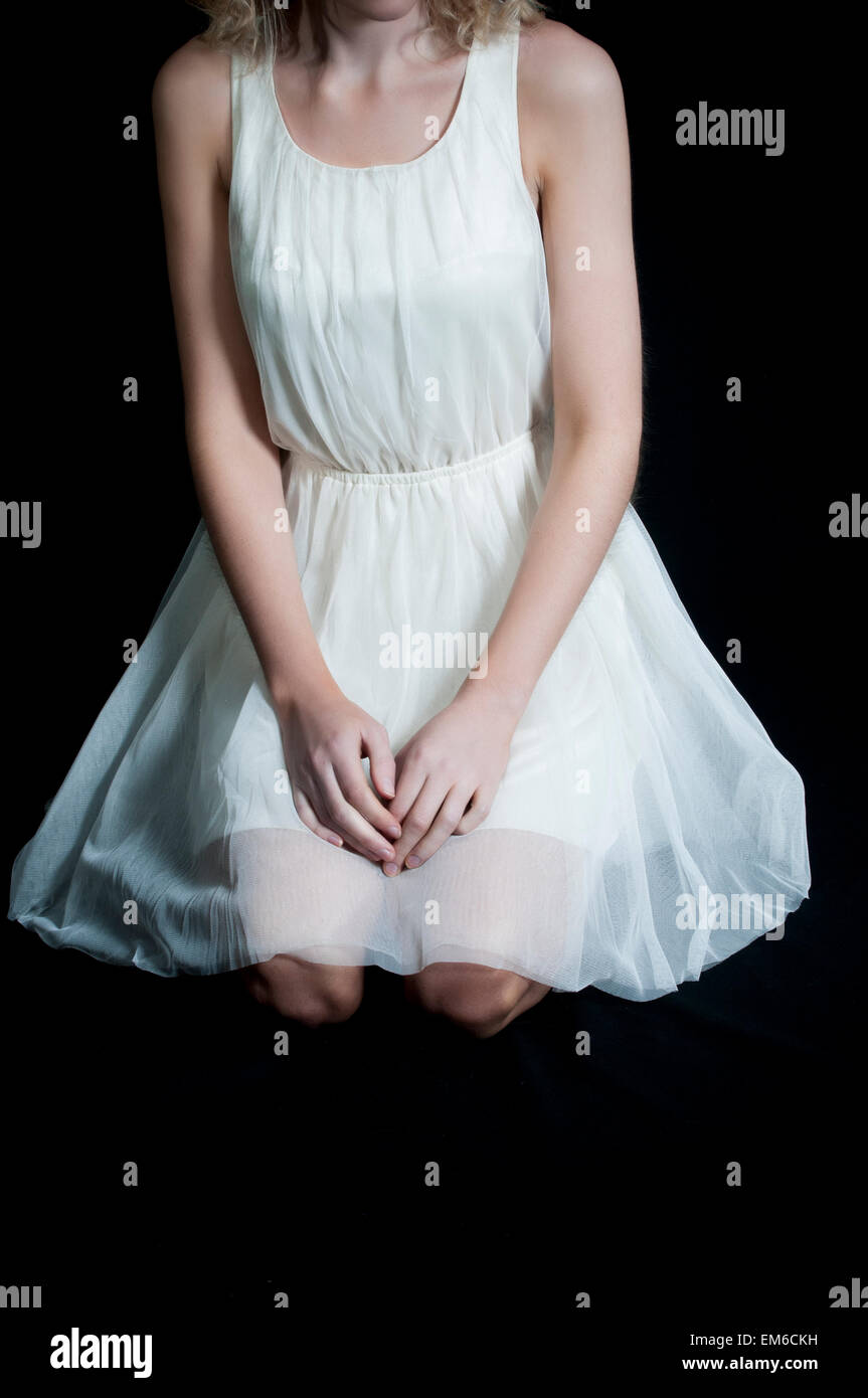 Young woman sat down Stock Photo - Alamy