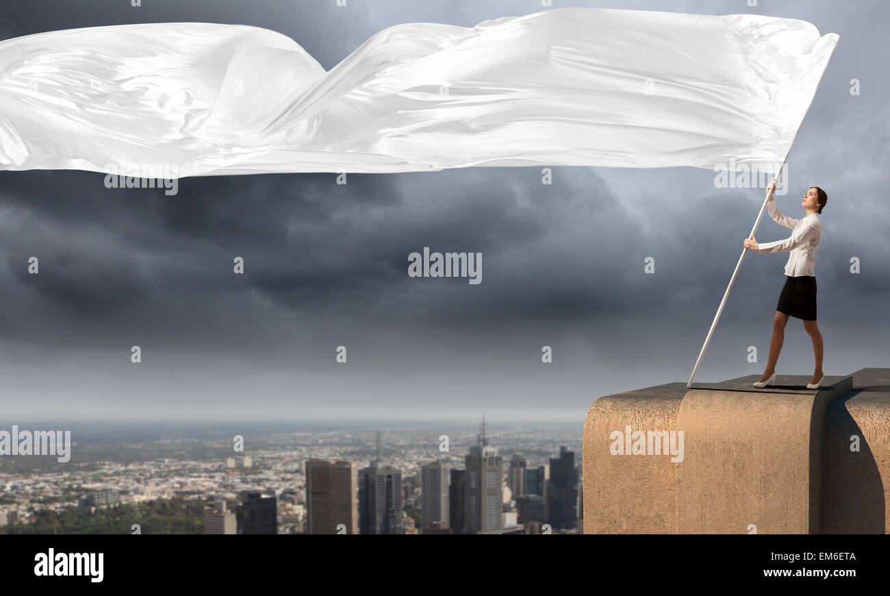 Businesswoman holding white flag Stock Photo - Alamy