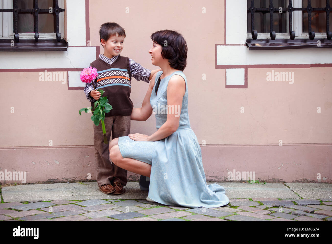 Little boy giving flower to his mom Stock Photo - Alamy