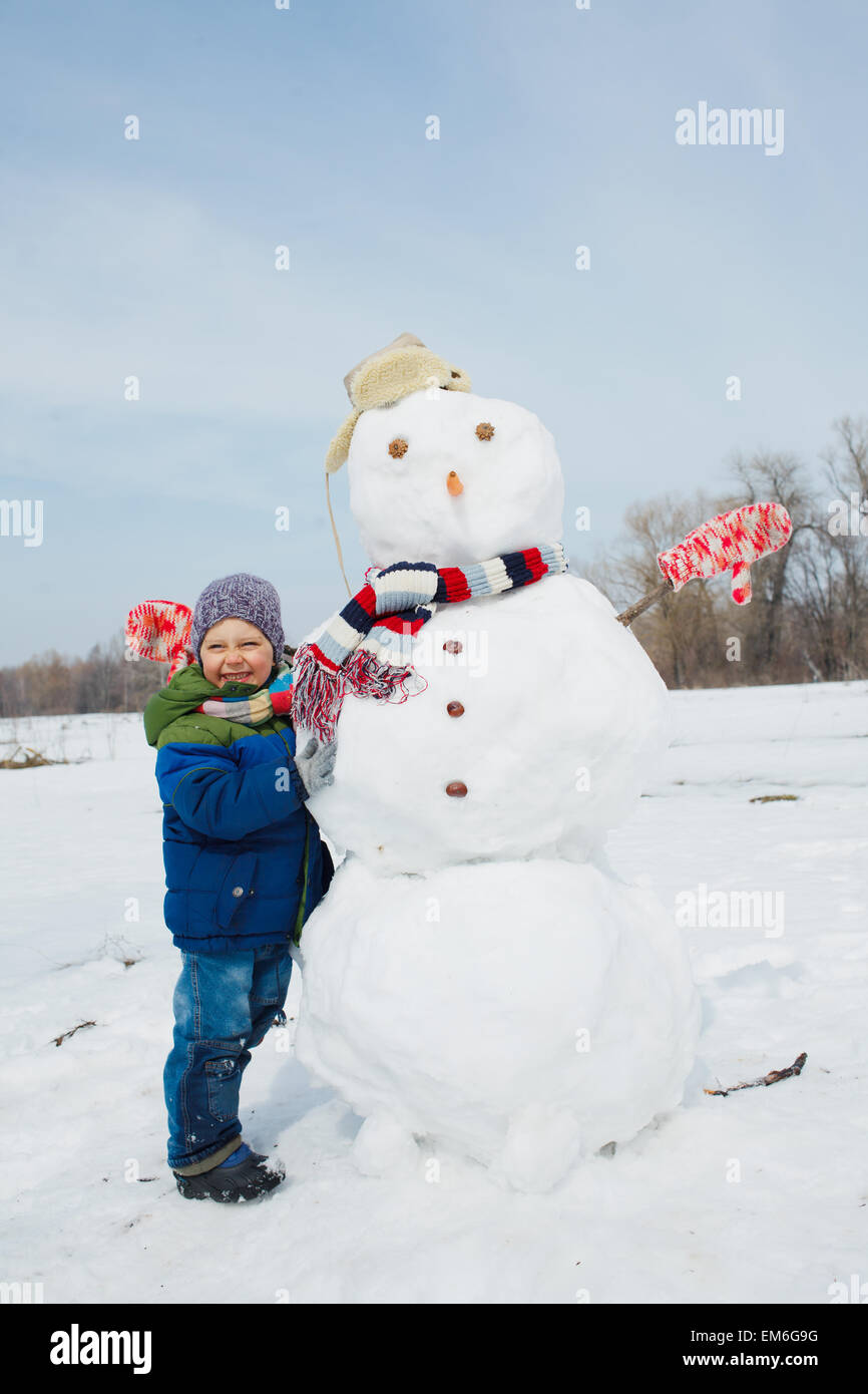 Boy makes a snowman Stock Photo - Alamy