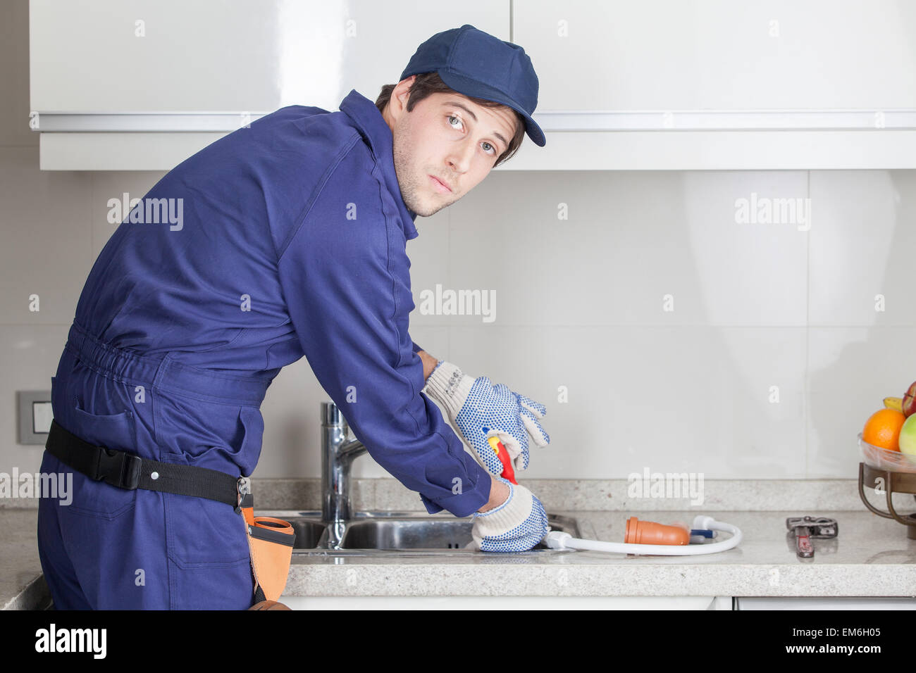 plumber fixing the kitchen Stock Photo - Alamy