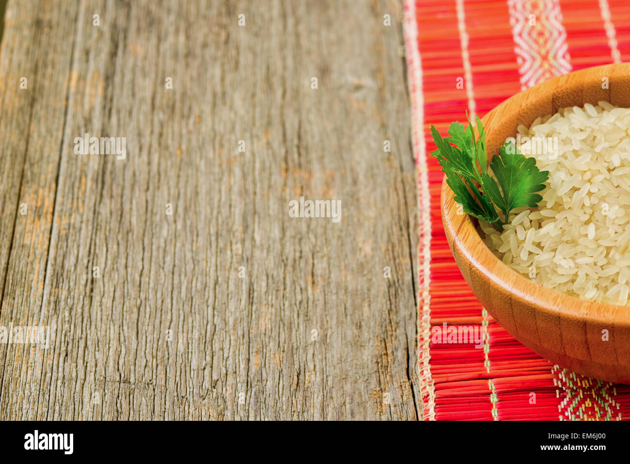 Isolated bowl with brown uncooked rice and leaf of parsley Stock Photo ...