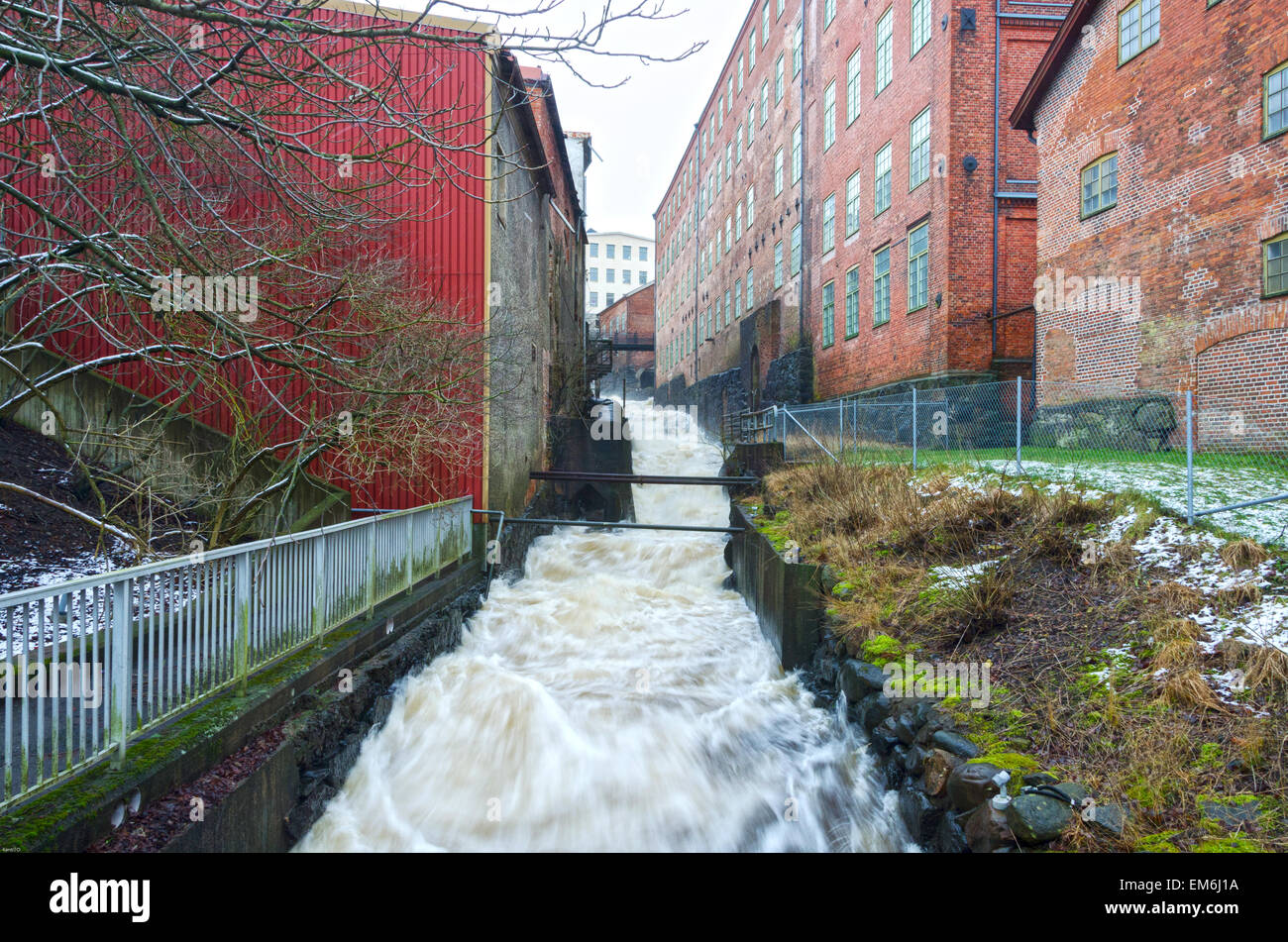 rushing water rushing down from a factory of many building Stock Photo ...