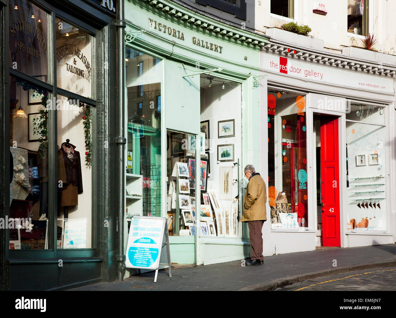 United Kingdom, Scotland, Man looking at window display on West Bow ...