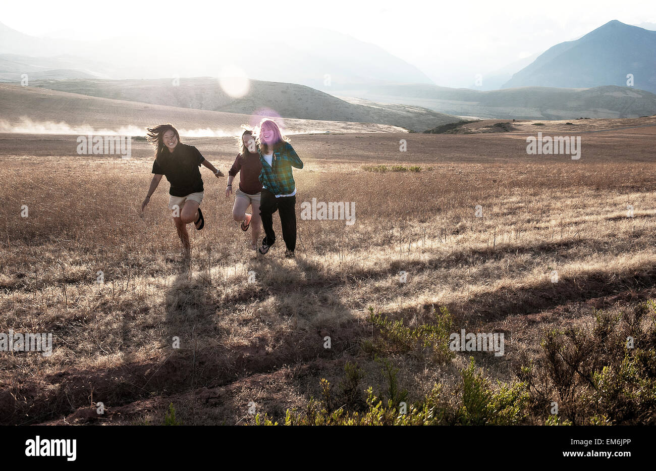 three girls running in peru Stock Photo - Alamy