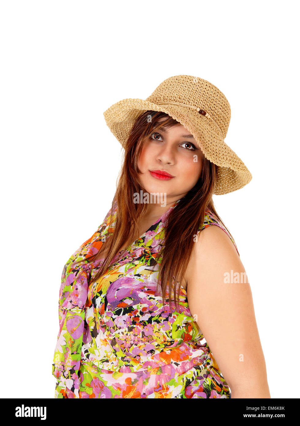A portrait shot of a serious looking young woman wearing a straw hat ...