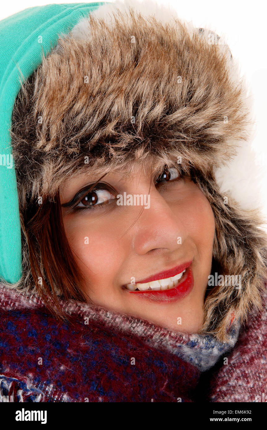 A closeup head shoot of a young woman with a big scarf around her neck ...