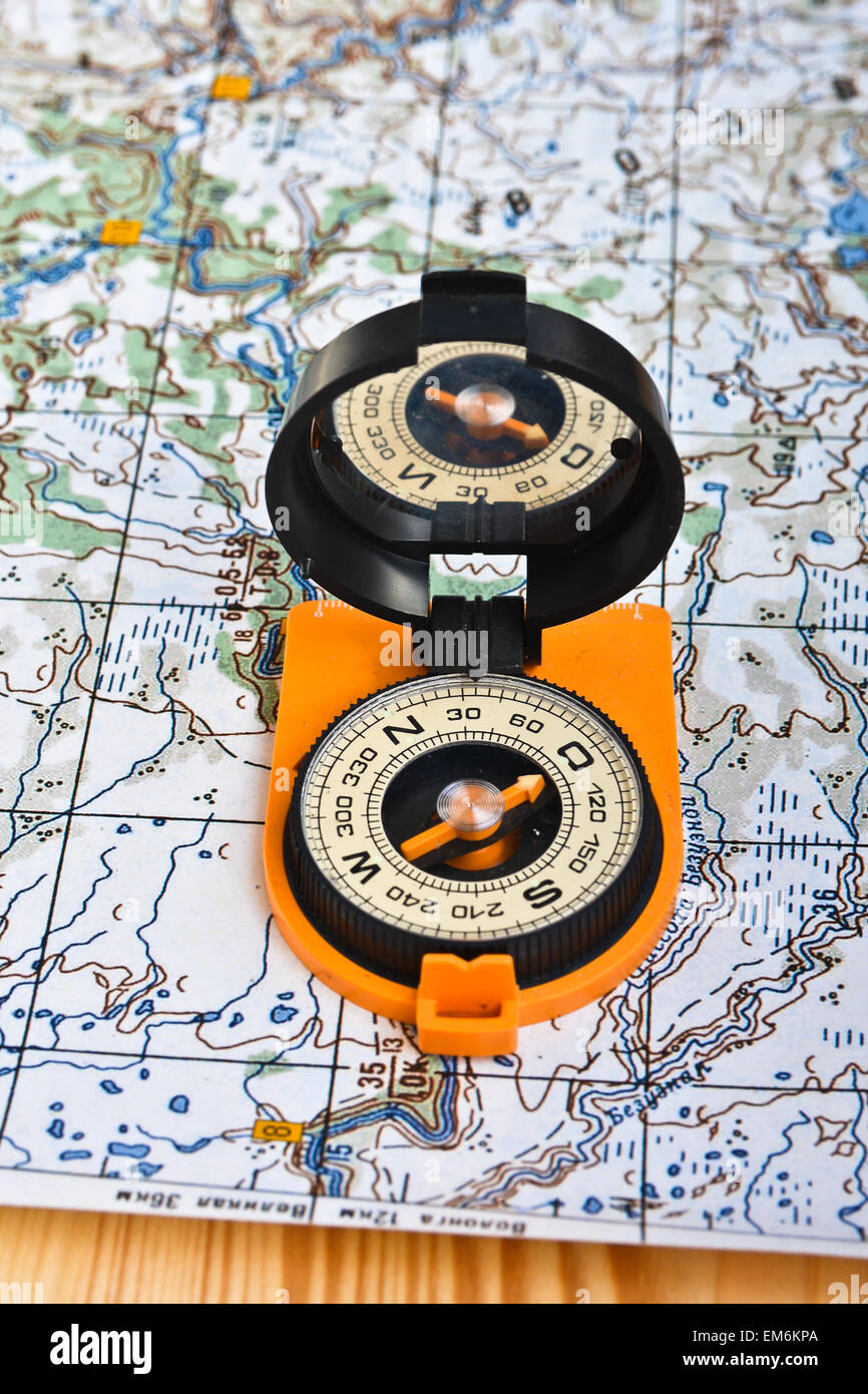The compass on the map. Photo magnetic compass located on a topographic ...