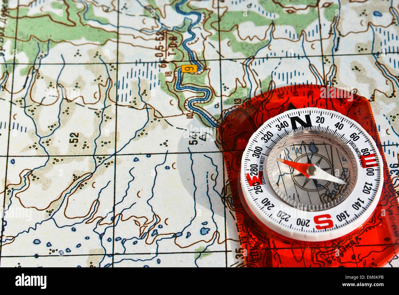 The compass on the map. Photo magnetic compass located on a topographic ...