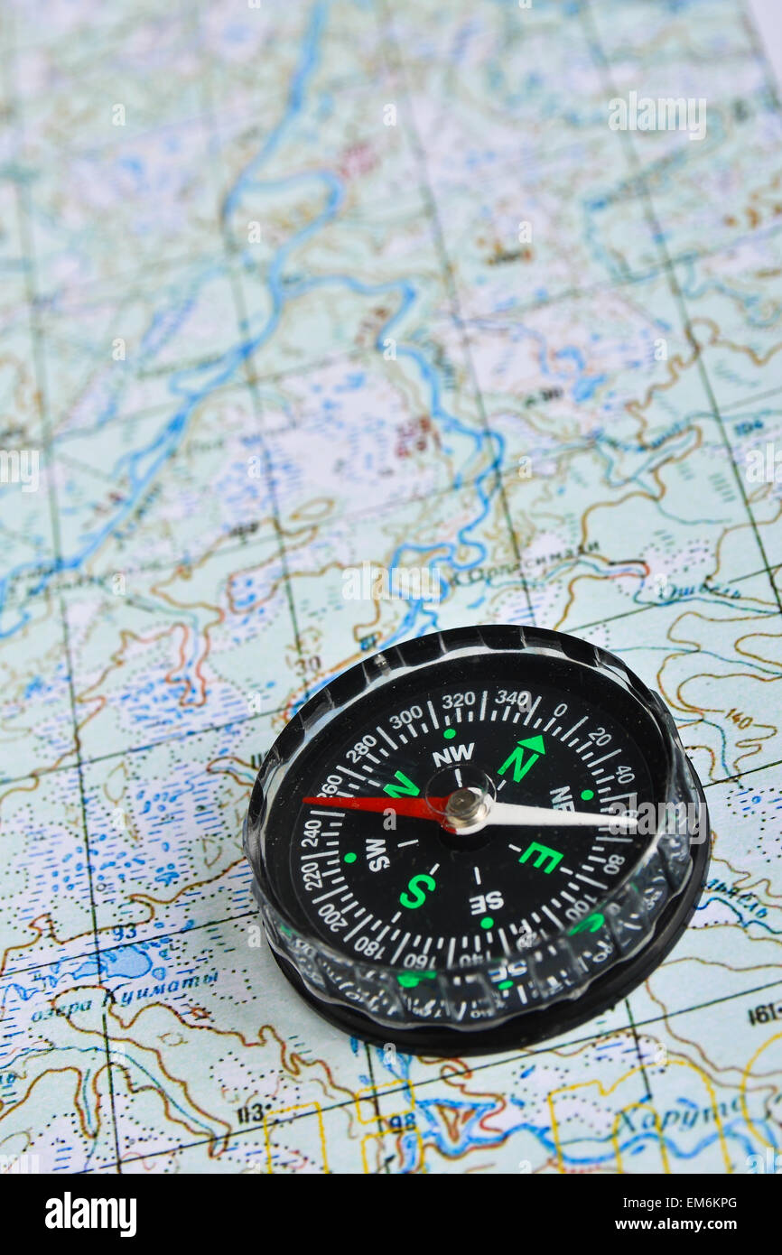Map and compass. Photo magnetic compass located on a topographic map ...