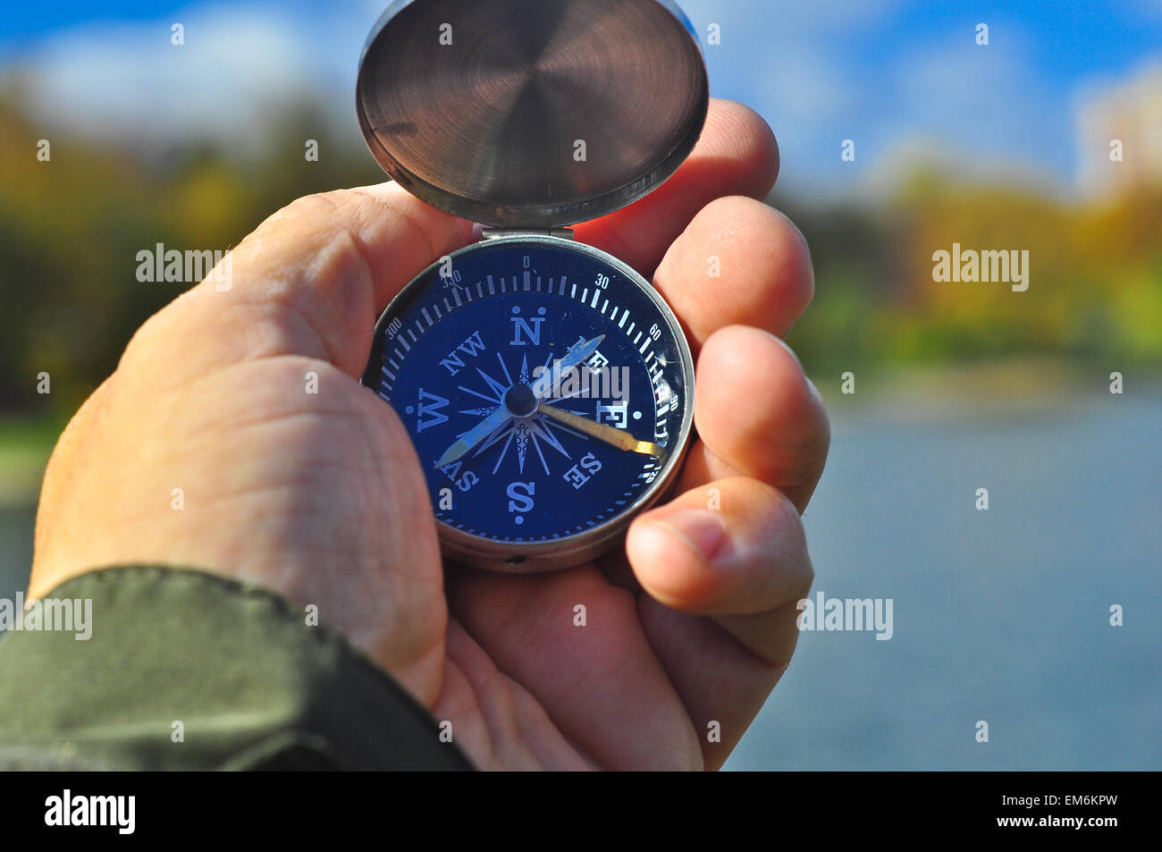Compass in hand. Magnetic compass in hand on the autumn landscape Stock ...
