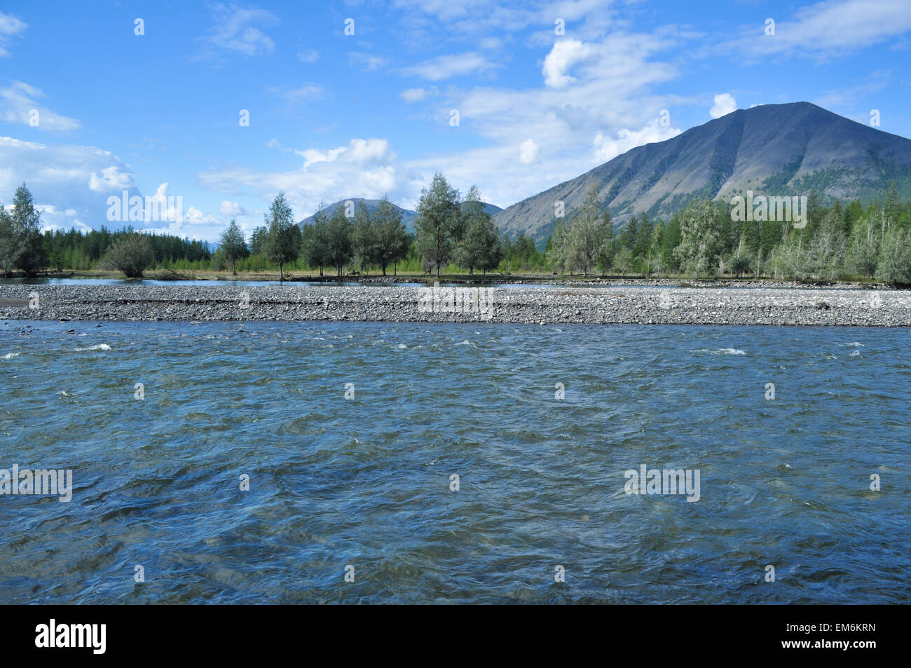 River flowing in a mountain valley. Landscape wildlife. Russia, Yakutia ...