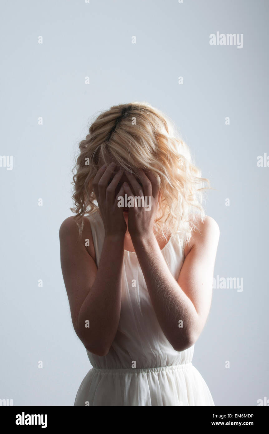 Miserable woman head in hands Stock Photo - Alamy