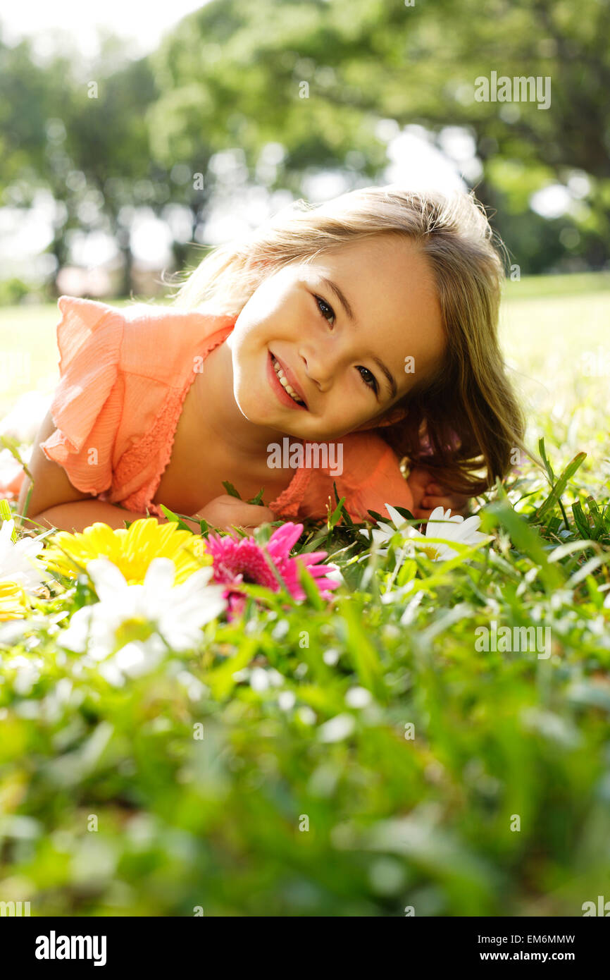 Girl Playing With Flowers In The Grass Stock Photo - Alamy
