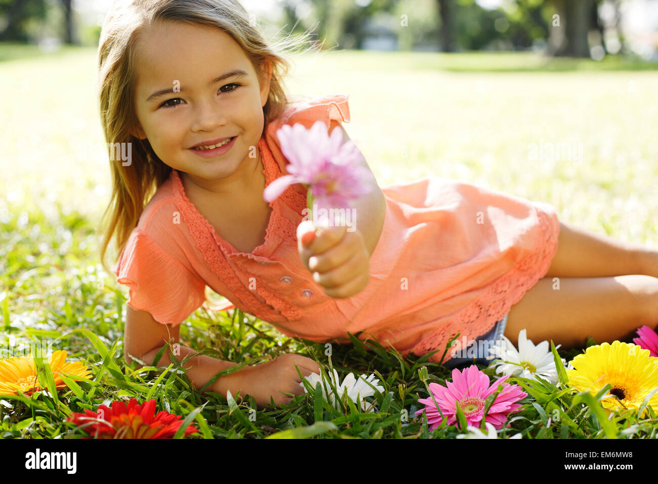Girl Playing With Flowers In Grass Stock Photo - Alamy