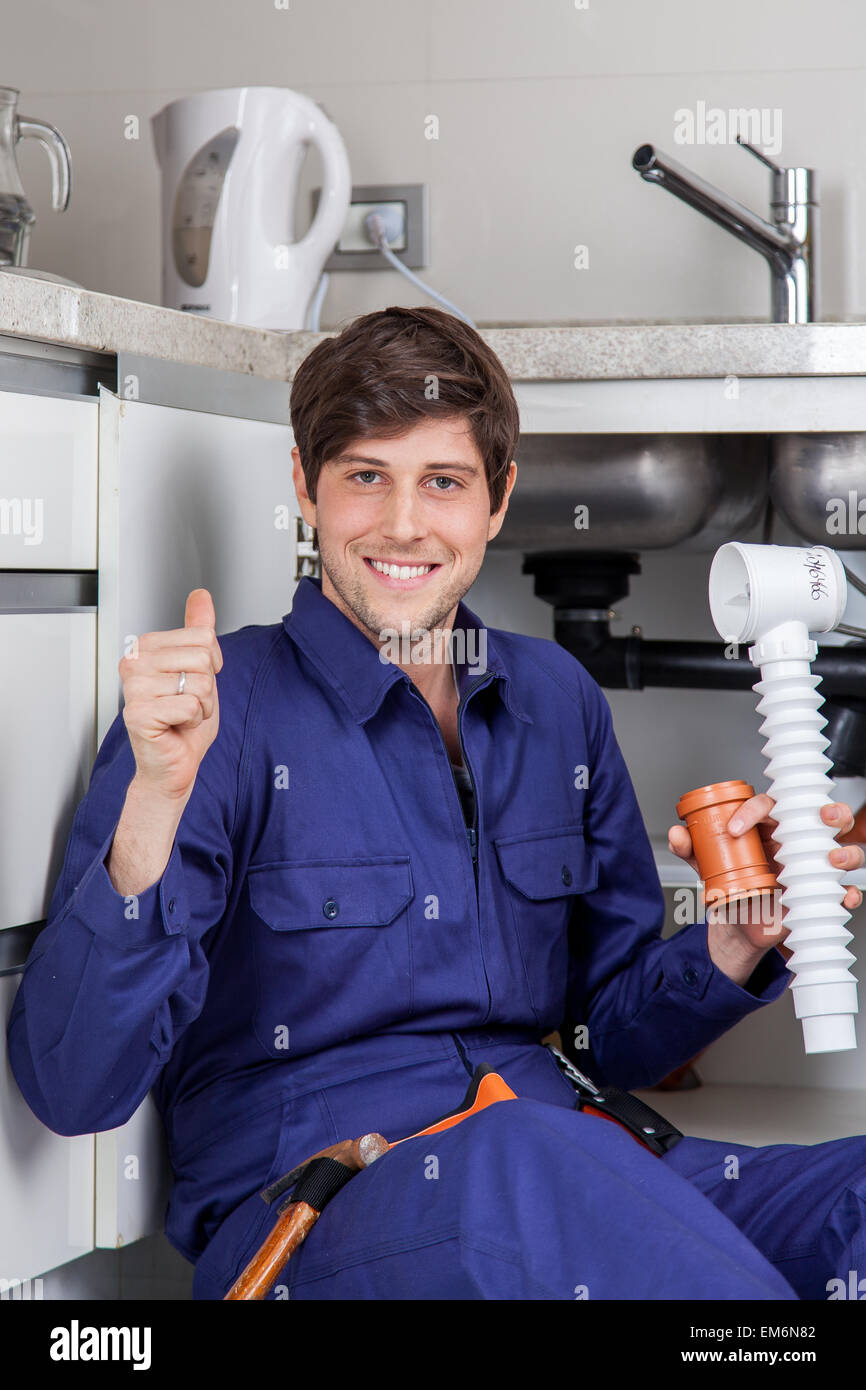 plumber fixing the kitchen Stock Photo - Alamy