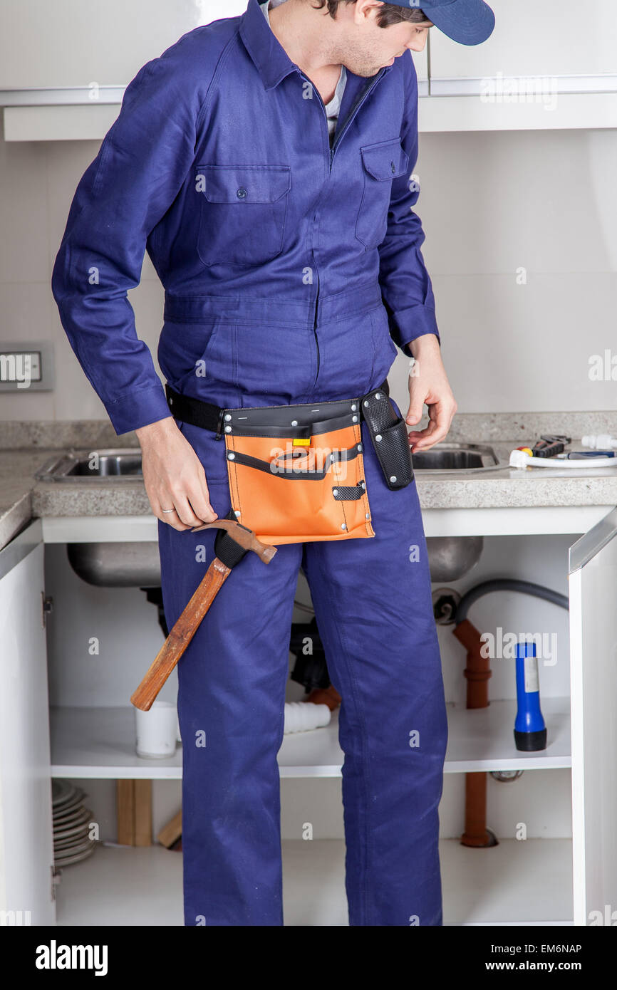 plumber fixing the kitchen Stock Photo - Alamy