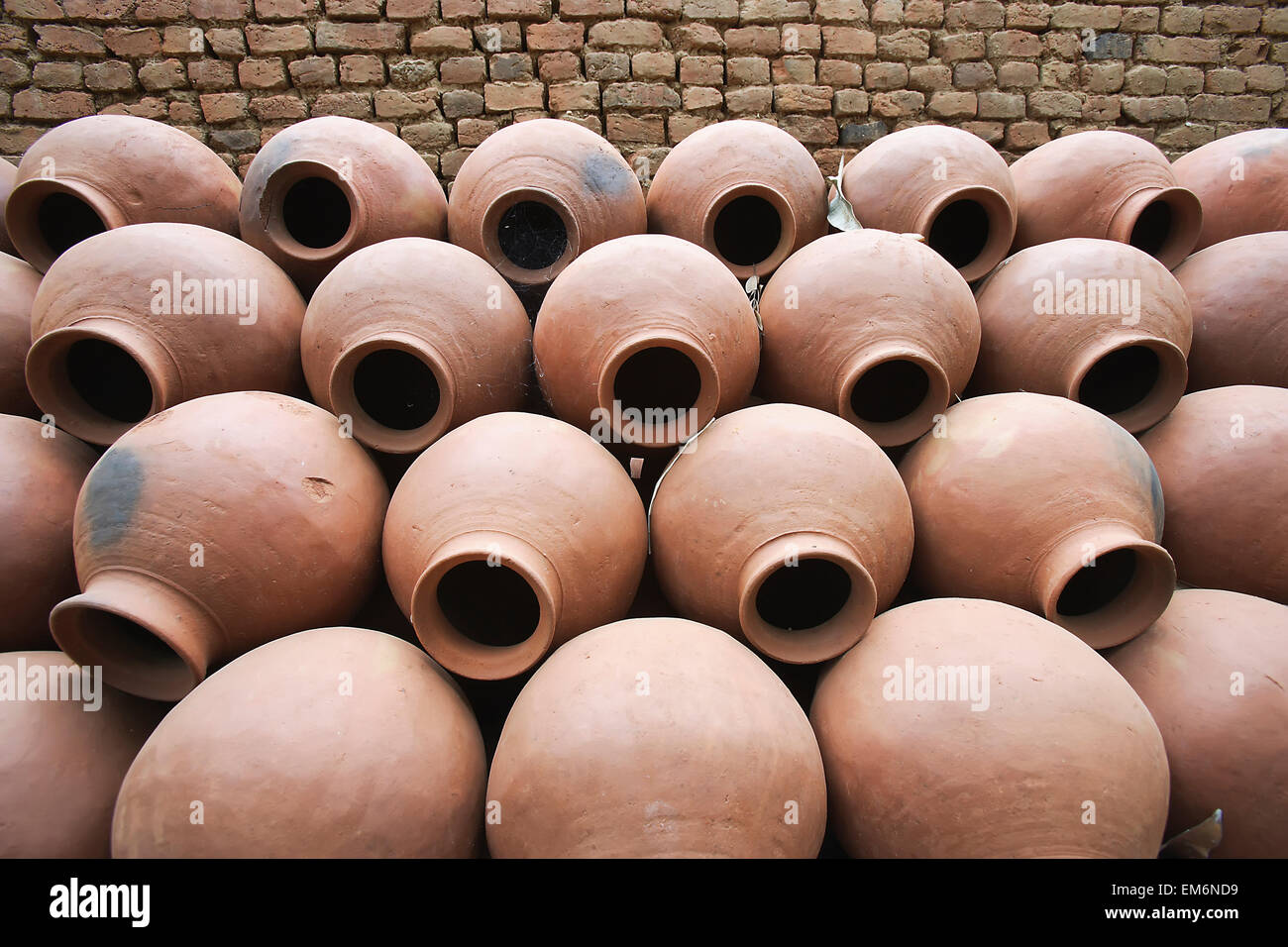 Handmade traditional ceramic water pots lying upurchased beside a kiln ...