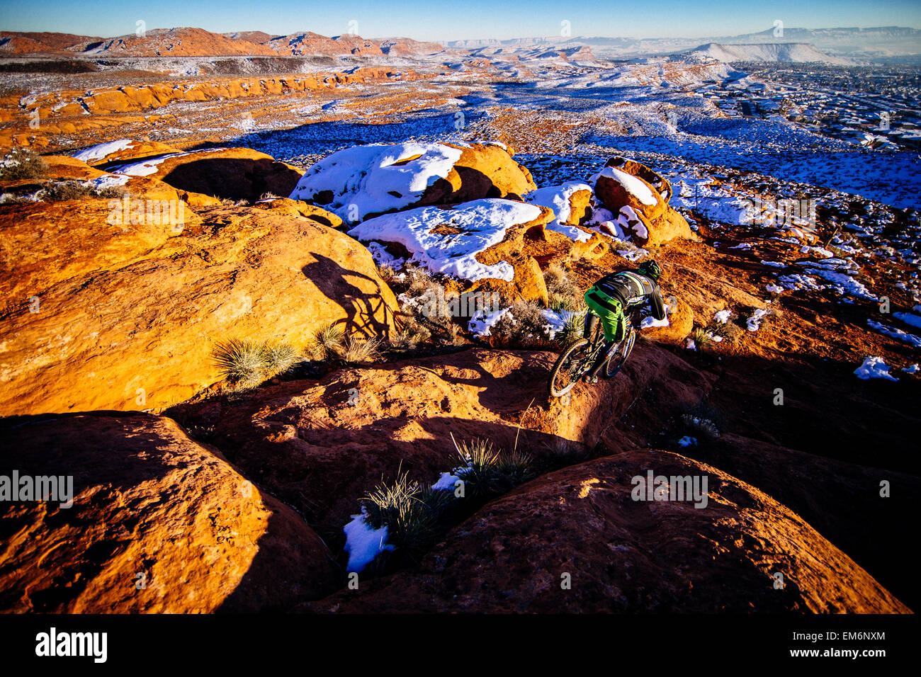 A man riding his mountain bike in the snow outside of St. George, Utah ...