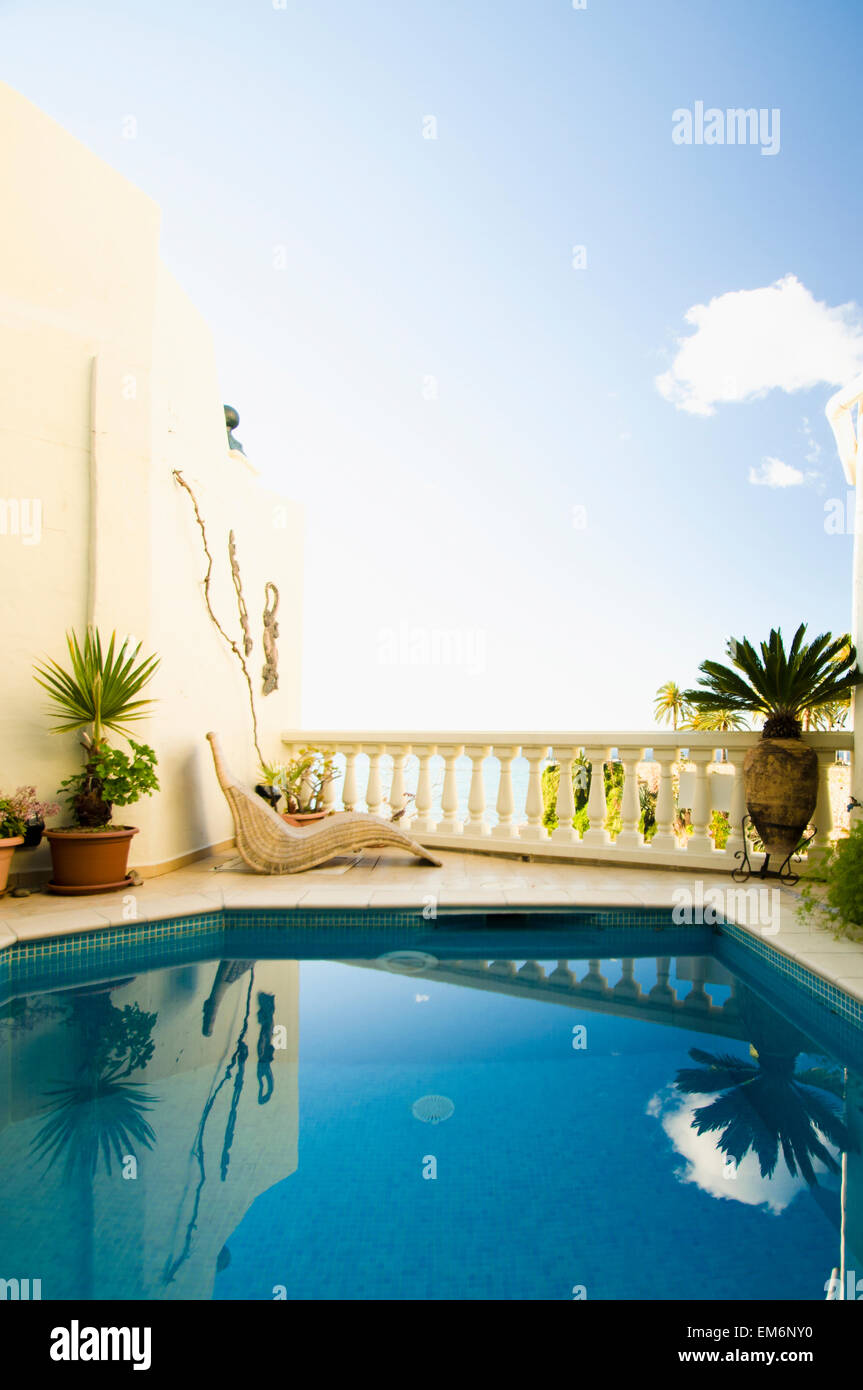 Swimming pool with reflected sky and clouds at a villa; Nerja ...