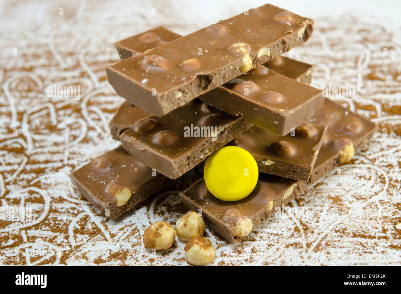 Bunch of hazelnut chocolate on a heart patterned table Stock Photo - Alamy