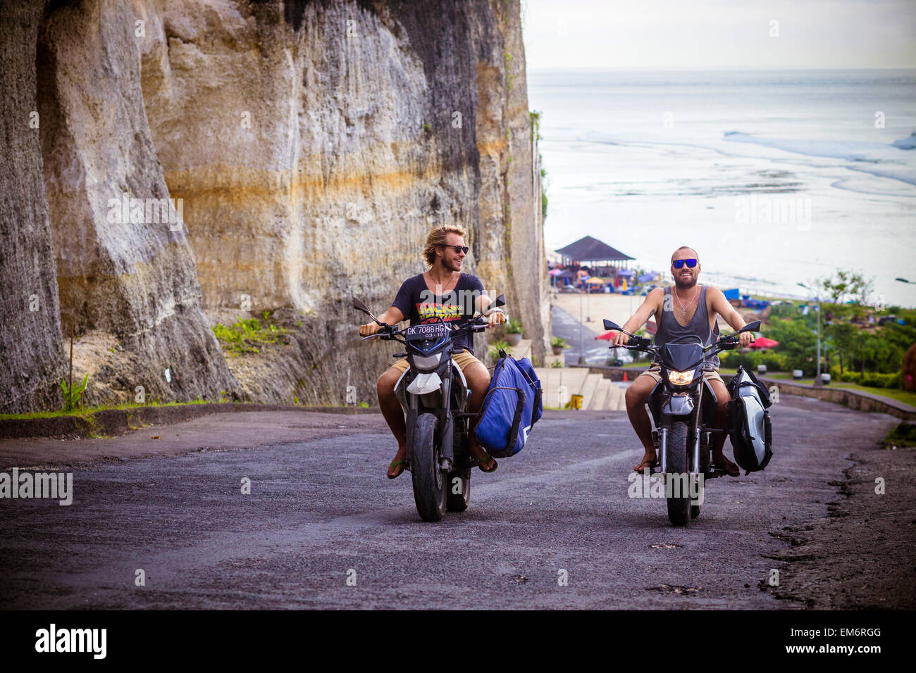 Man on motorcycle with surfboard at Bali Stock Photo - Alamy