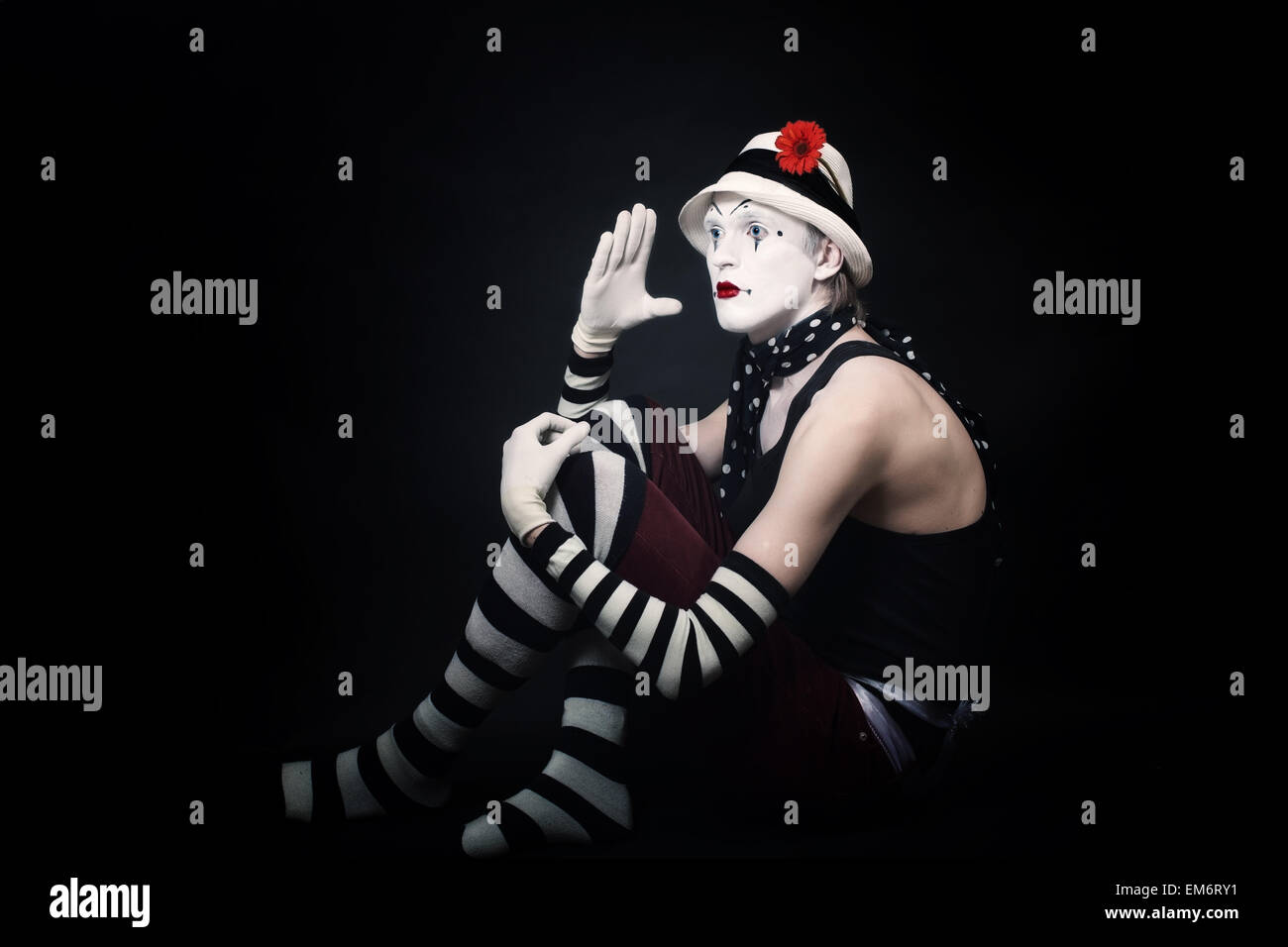 Dramatic funny mime in white hat on black background Stock Photo - Alamy