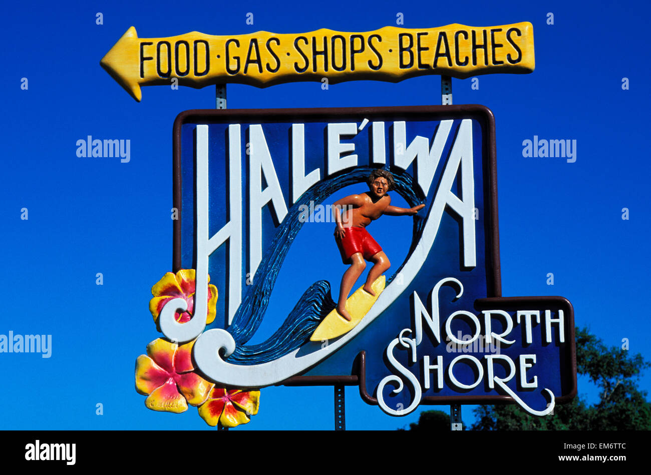 Haleiwa town sign with surfer on the side of the road; Haleiwa, Oahu ...