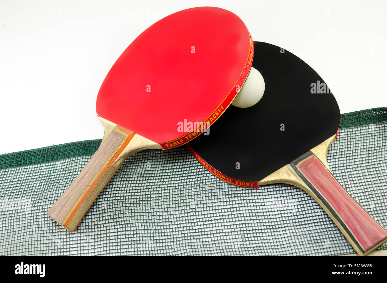 Two table tennis rackets one on top of the other and an old net ...