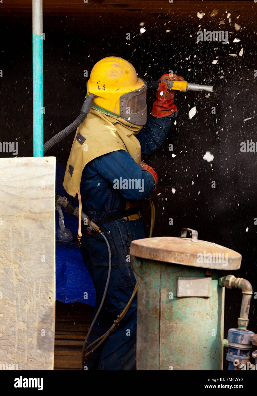 Construction worker in protective clothing and breathing apparatus ...