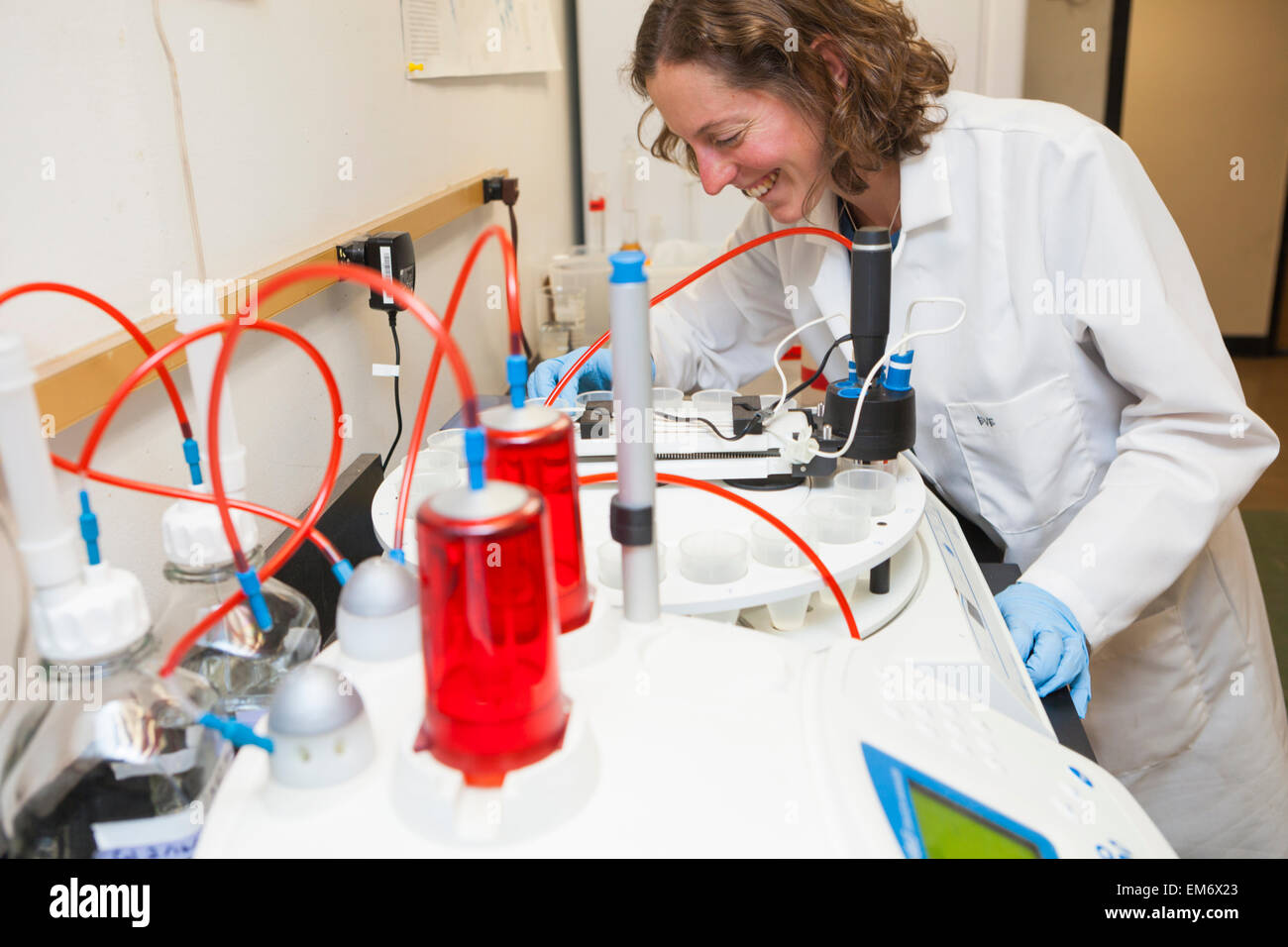 A woman analyzes water samples at an environmental chemistry laboratory ...