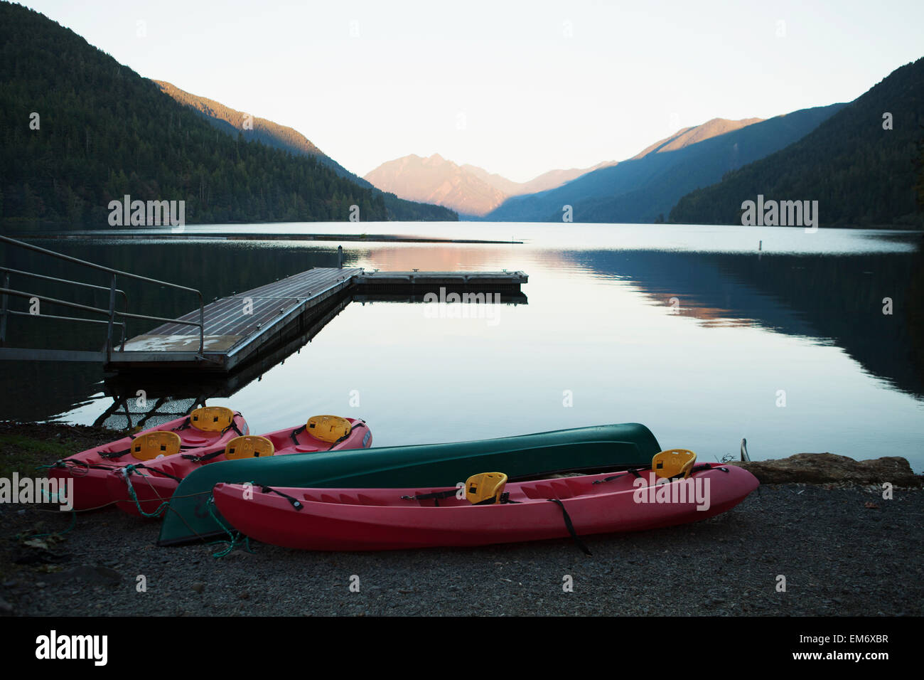 Kayaks on the shore of tranquil Lake Crescent at sunrise, Olympic ...