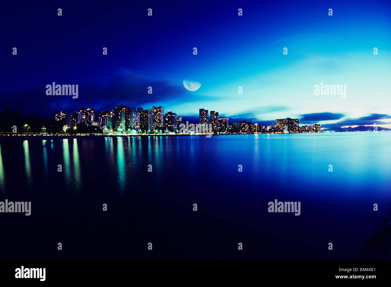 Hawaii, Oahu, Honolulu, Waikiki skyline at night, moon overhead, view ...