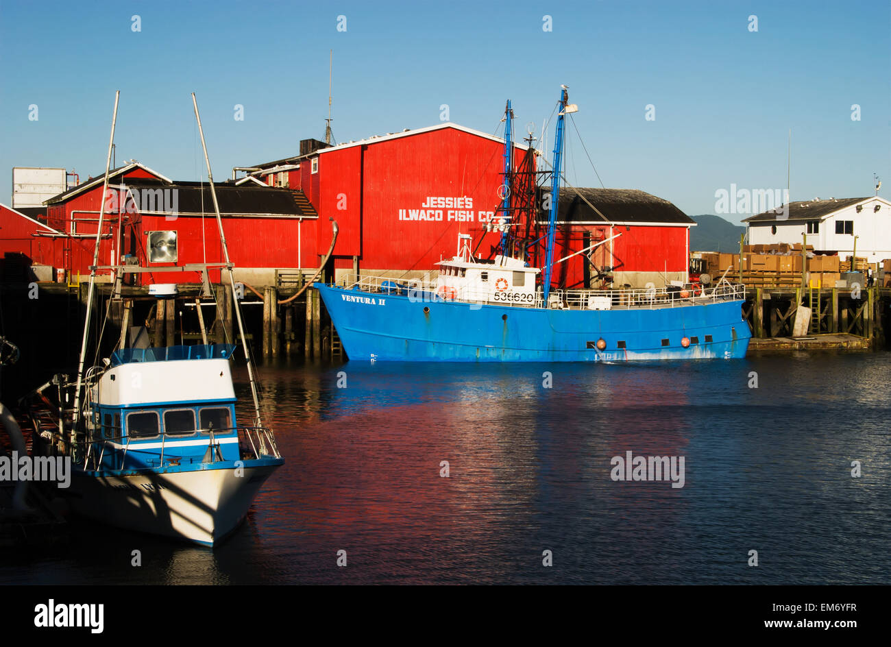 Bright red building and blue boat in the Port of Ilwaco; Ilwaco ...