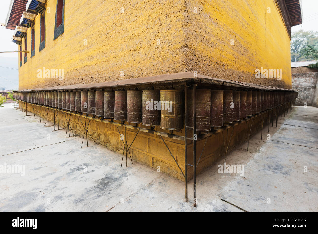 Buddhist temple wall with prayer wheels at Longwu Tibetan monastery ...