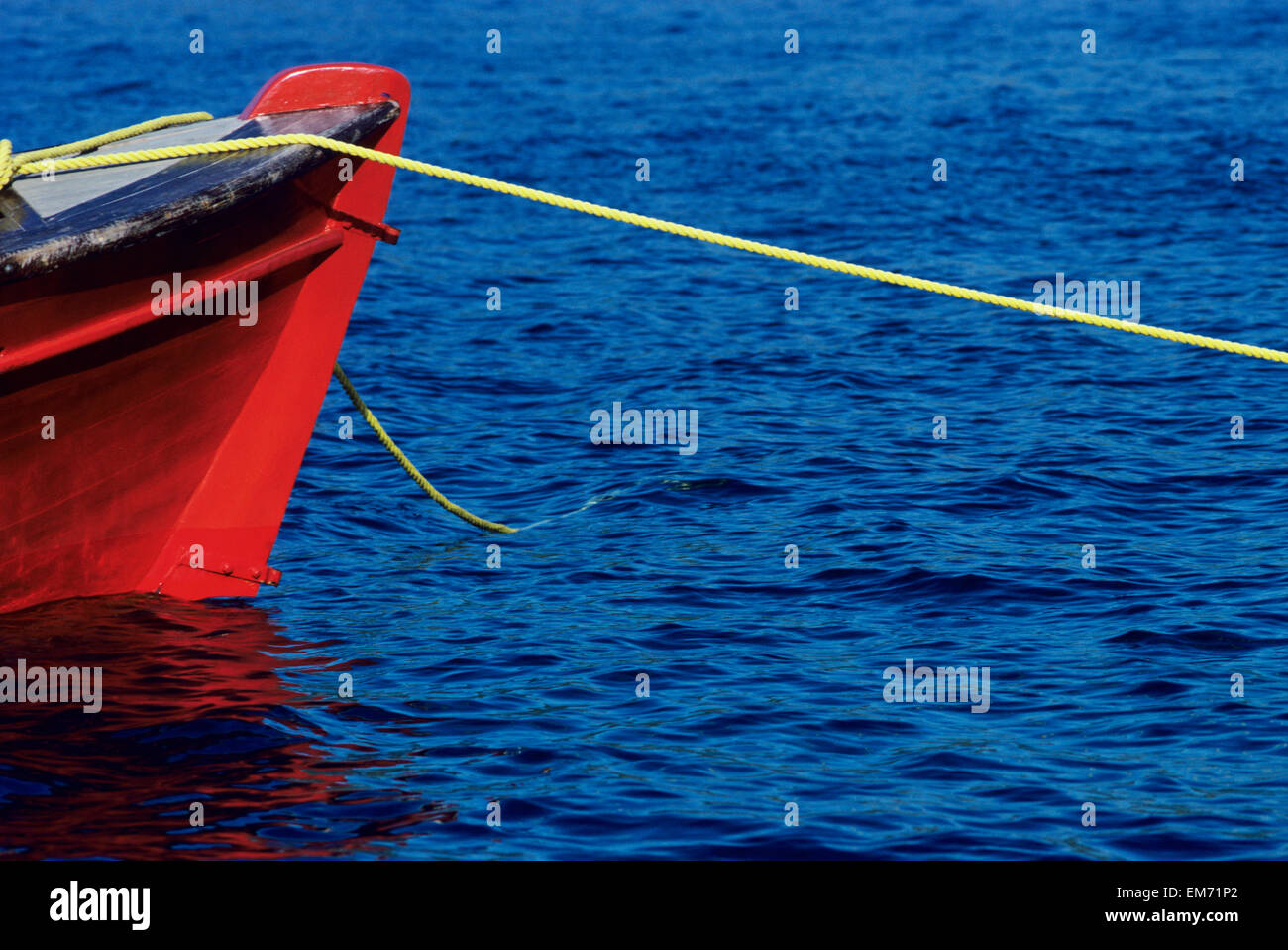 Bow Of Red Boat Secured By Rope Floating In Blue Ocean Water Stock ...