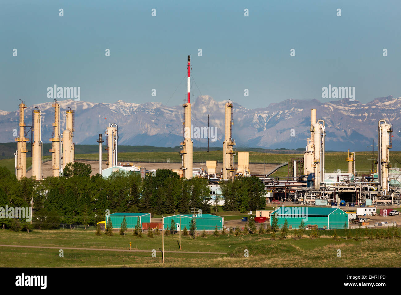 Gas plant with towers and mountains in the background with blue sky ...