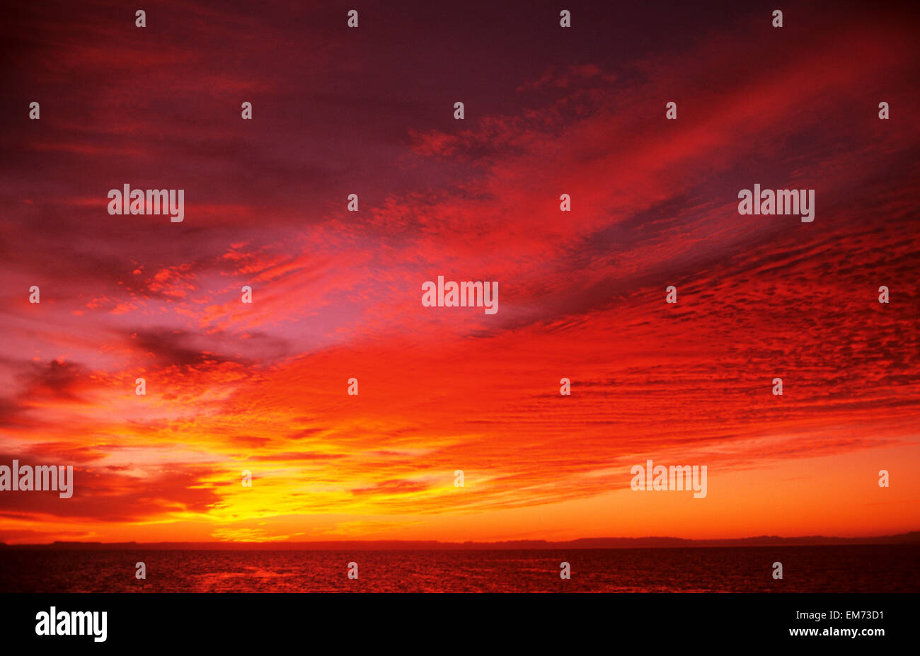 Bright Orange Sunset Over Ocean Stock Photo - Alamy