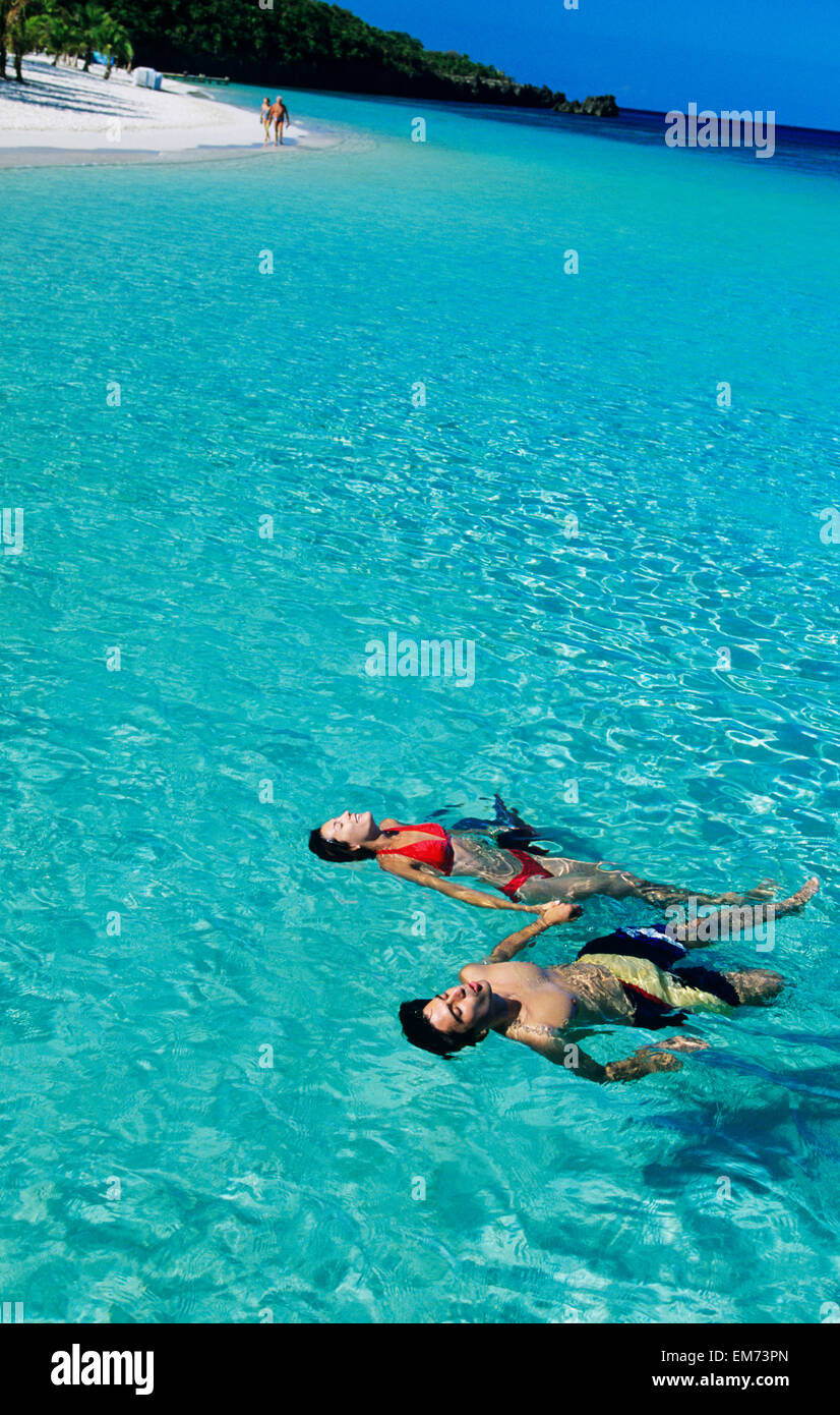 Caribbean, Honduras, The Bay Islands, Couple Floating In Clear ...