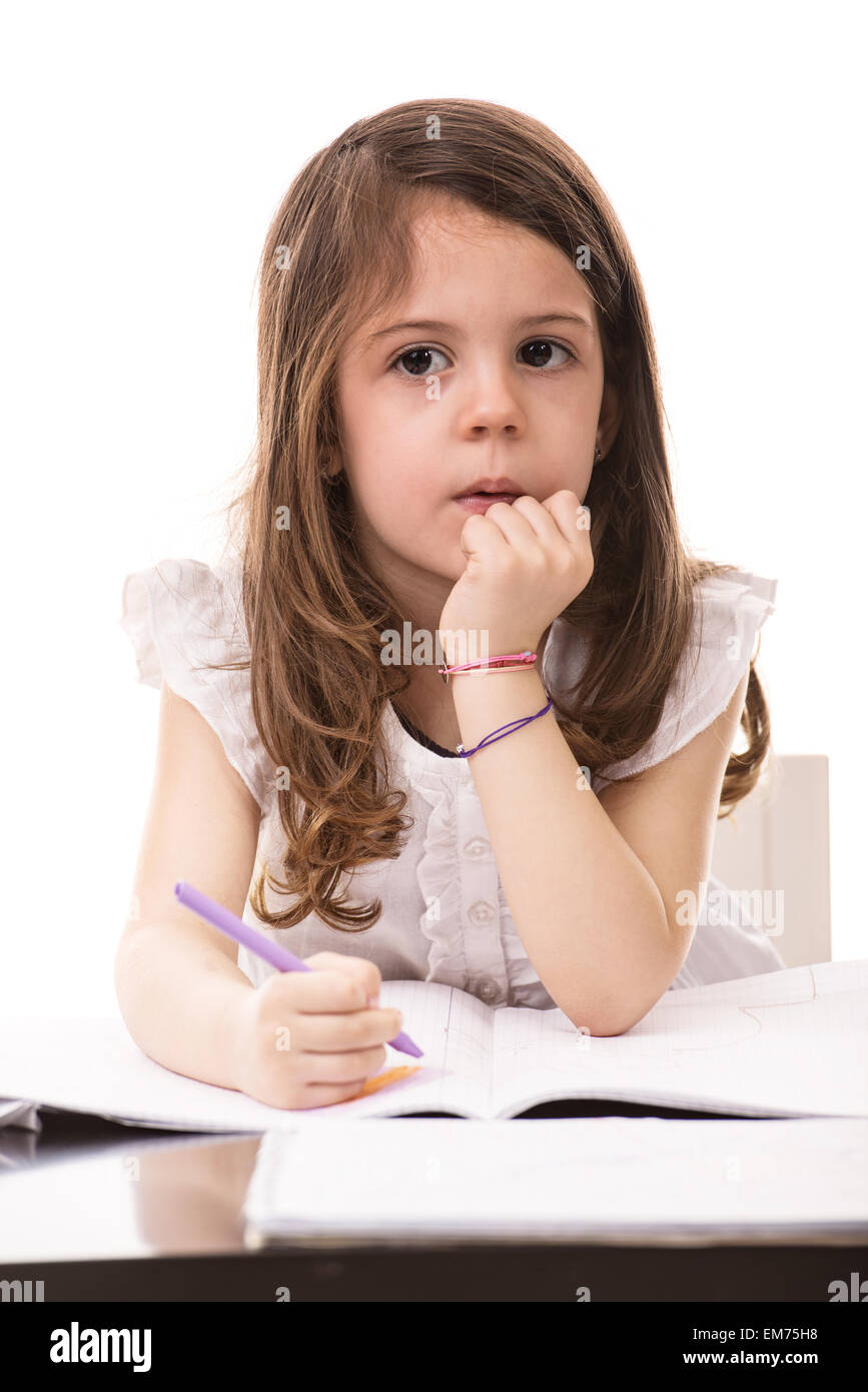 Thinking little girl drawing in kindergarten isolated on white ...