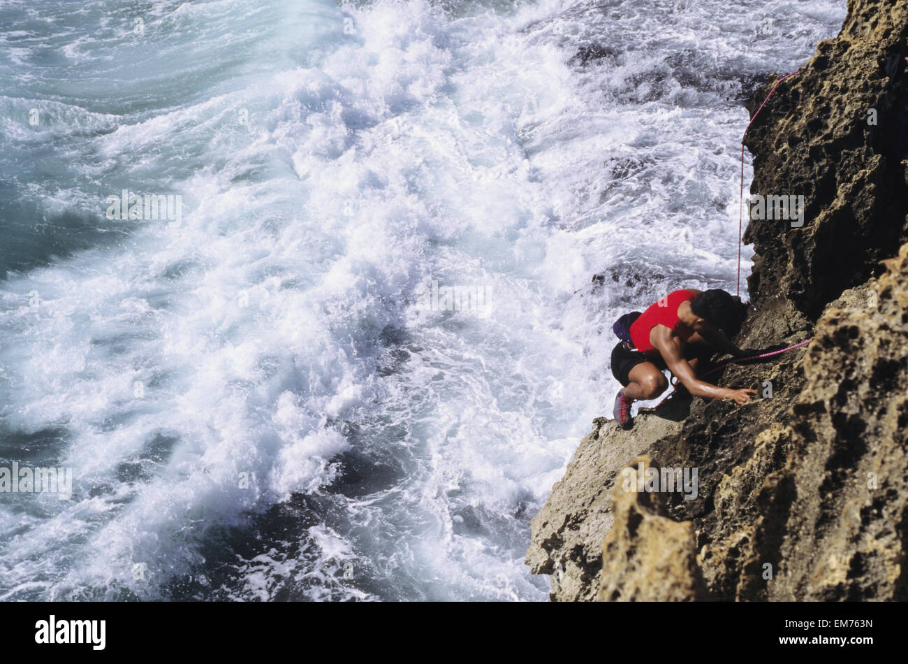 Hawaii, Kauai, Poipu, Rock Climber On Cliff Overhang, Waves Crashing ...