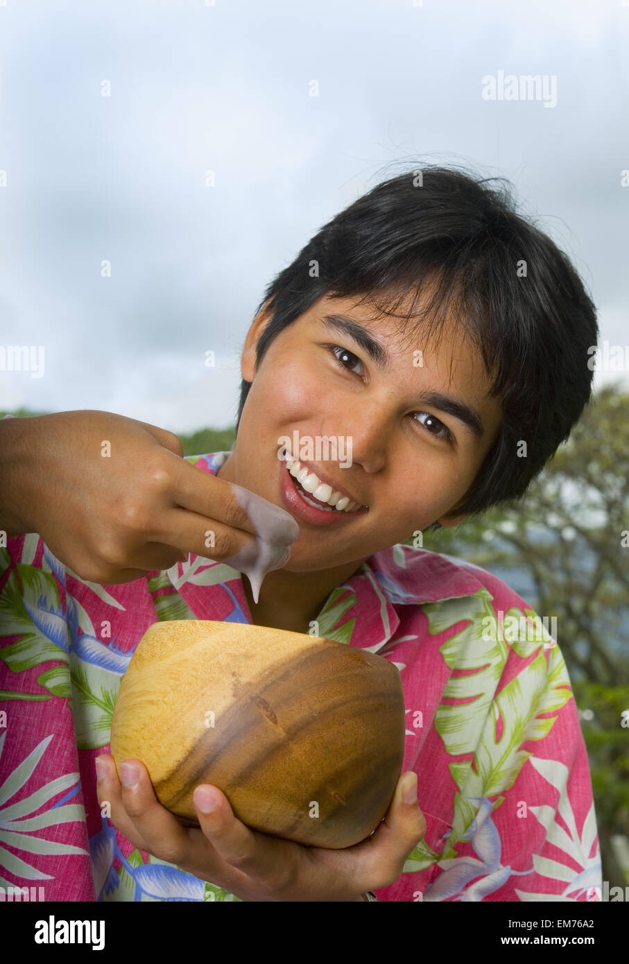 Hawaii, Young Man Eating Poi With Fingers Out Of Wooden Bowl Stock ...